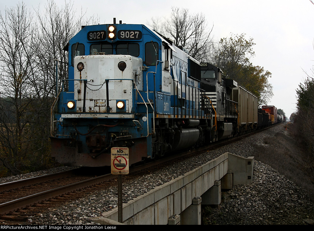 GMTX 9027 leads it's train south across a small bridge